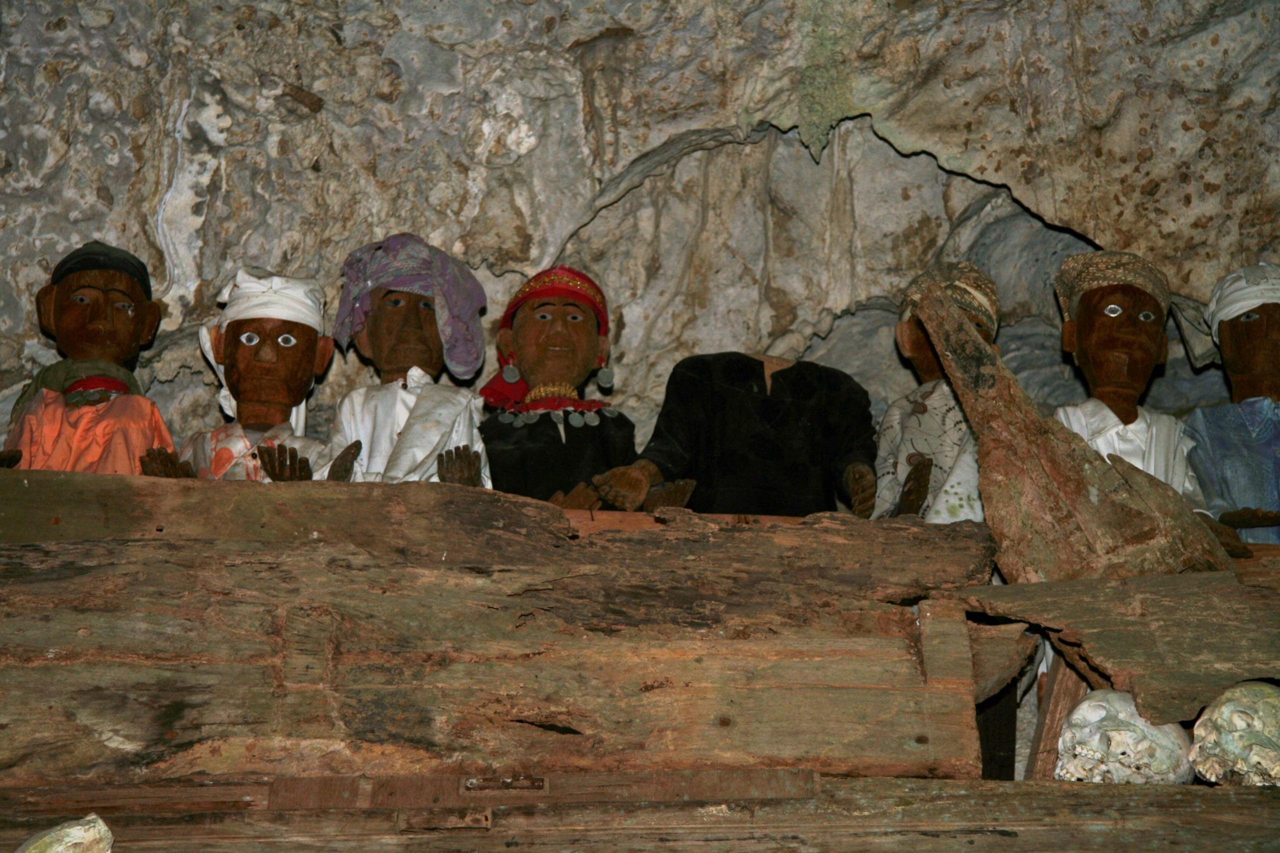 Coffins and wooden funeral effigies in cave at Londa Nanggala (Toraja ...